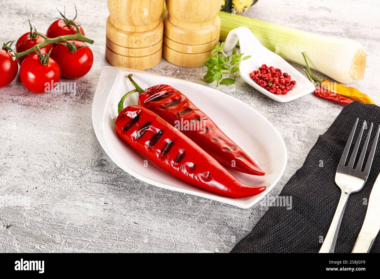Grilled red spicy pepper snack in the bowl Stock Photo - Alamy