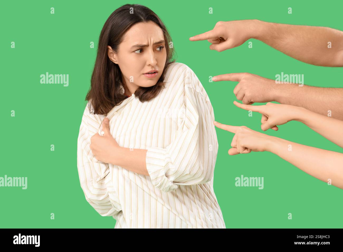 People pointing at scared young woman on green background. Accusation ...