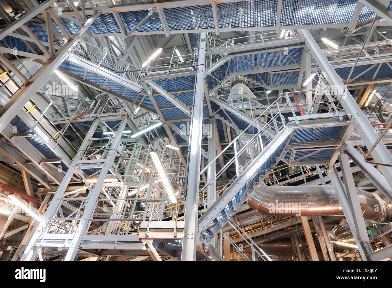 Intricate network of pipelines and stairs inside a chemical plant ...