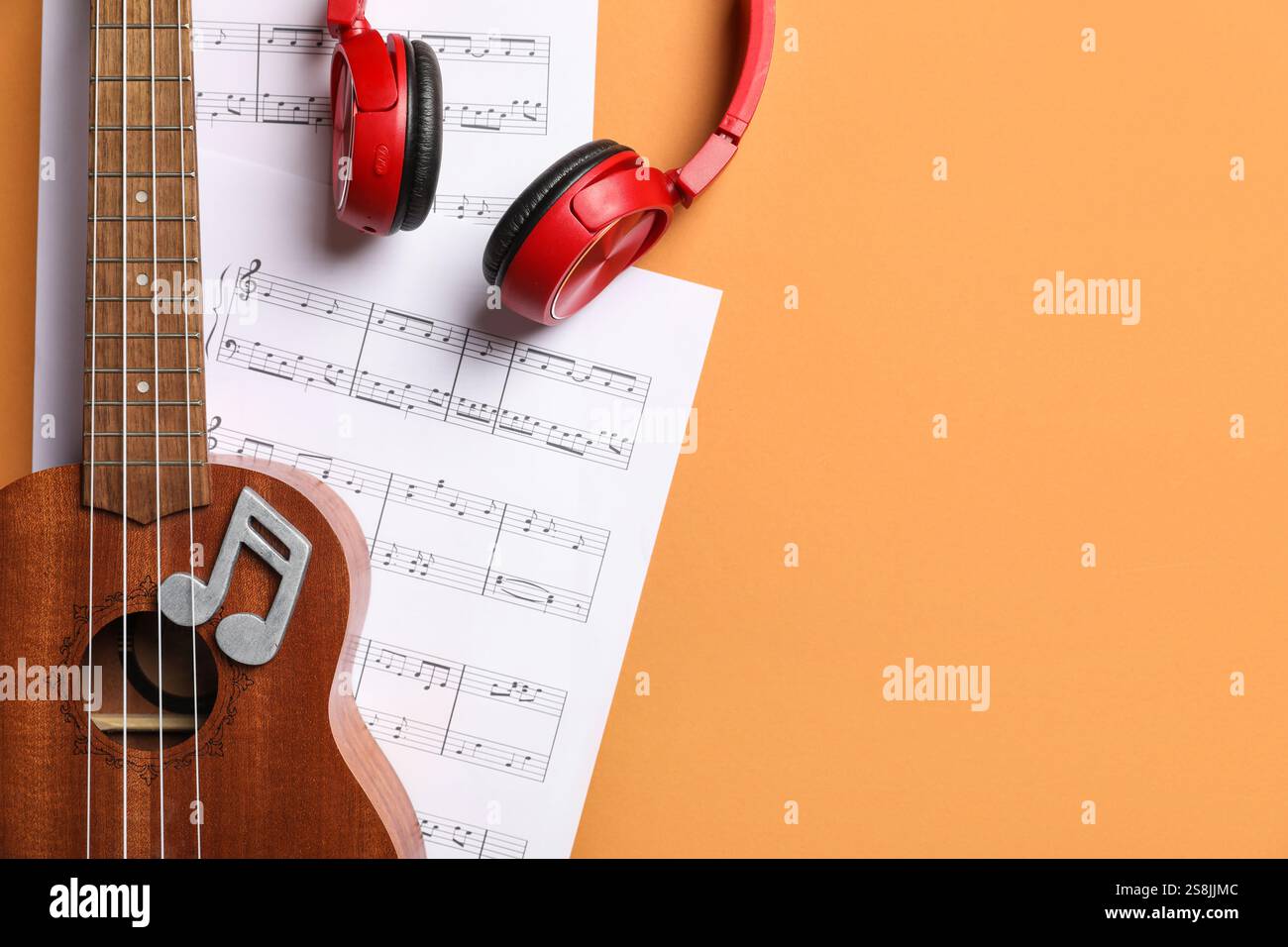Ukulele, modern headphones and music sheets on color background Stock ...