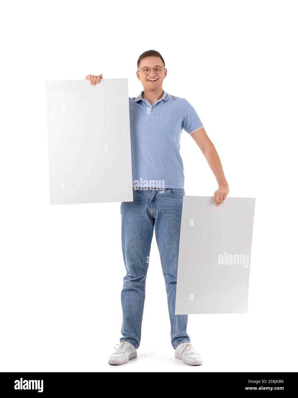 Handsome young man with blank posters on white background Stock Photo ...