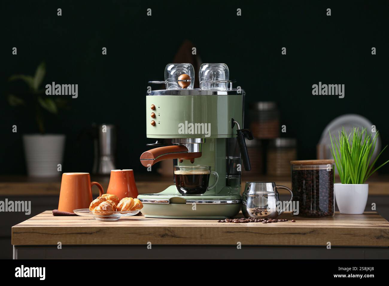 Modern coffee machine with glass of hot espresso and plate of sweet ...