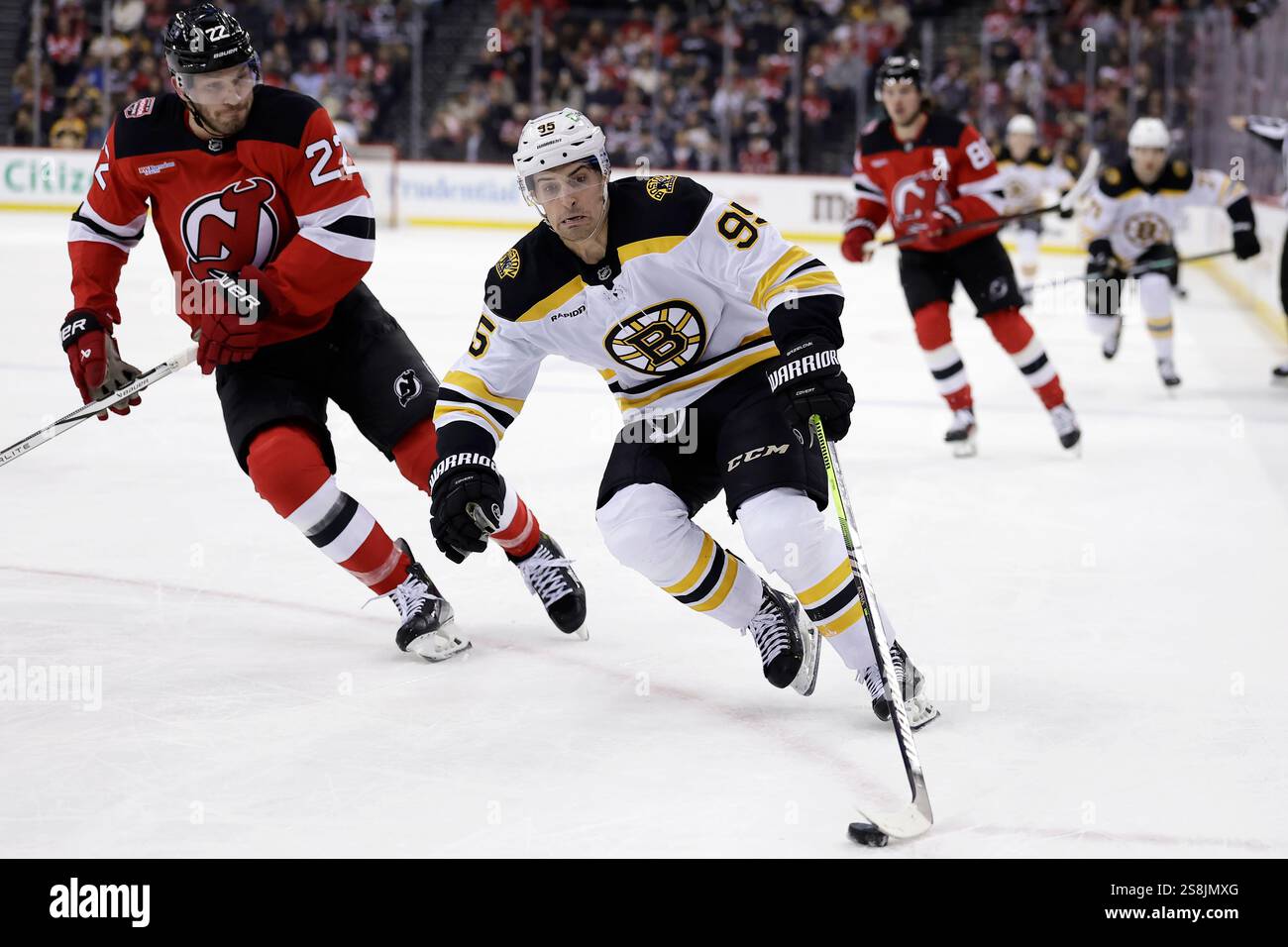 Boston Bruins center Vinni Lettieri (95) controls the puck past New ...