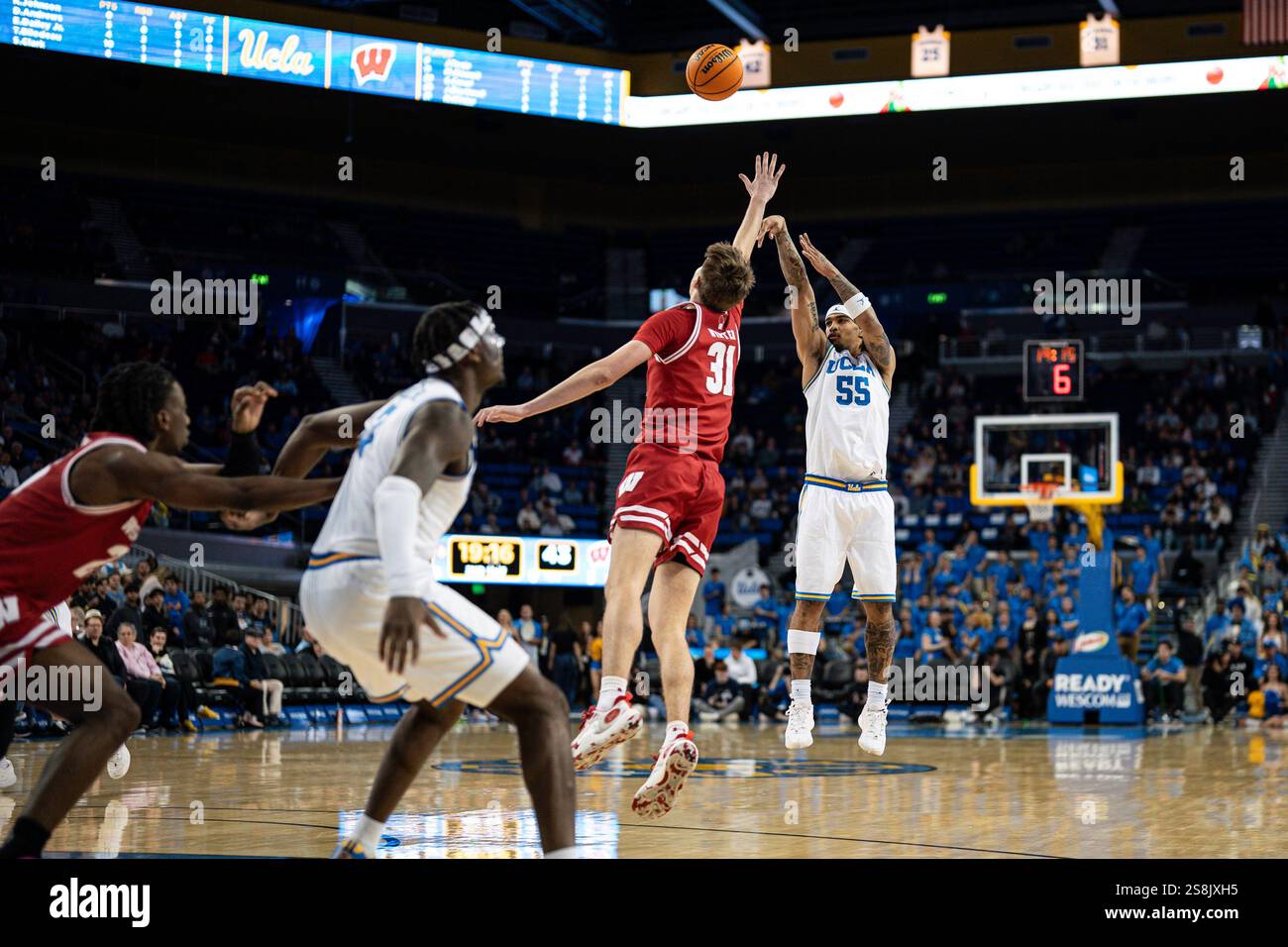 UCLA Bruins guard Skyy Clark (55) shoots over Wisconsin Badgers forward ...