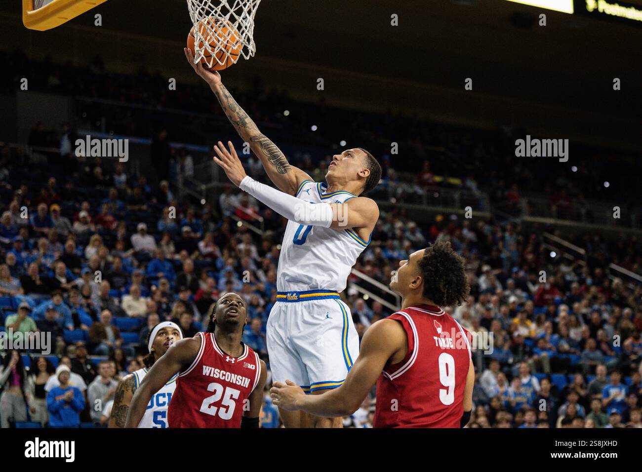 UCLA Bruins guard Kobe Johnson (0) scores against Wisconsin Badgers ...