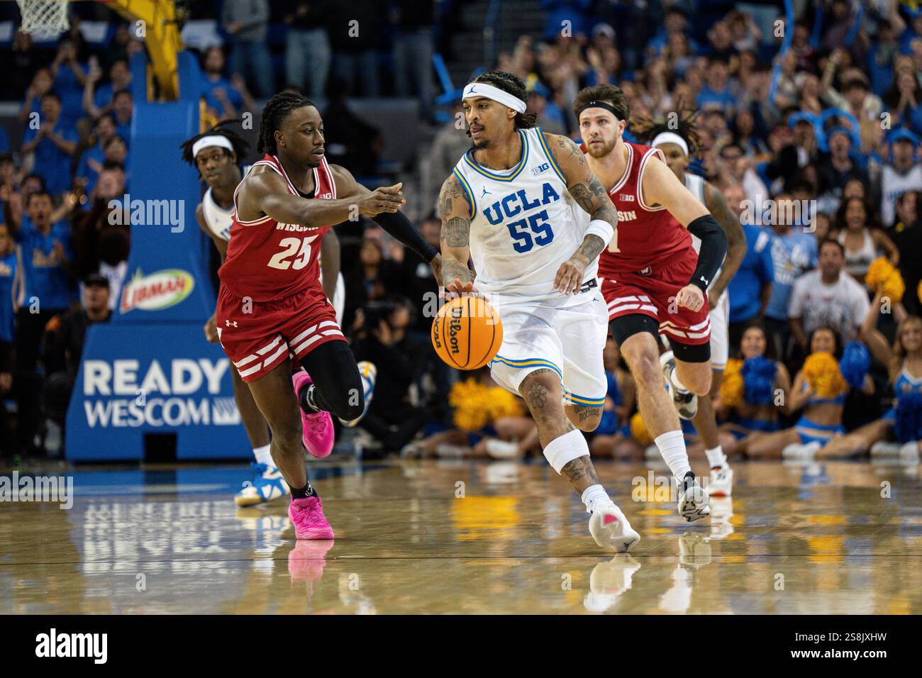 UCLA Bruins guard Skyy Clark (55) is fouled by Wisconsin Badgers guard ...