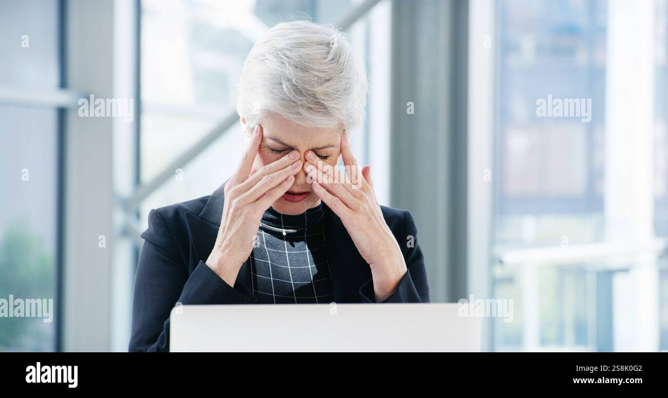 Laptop, headache and mature woman in office, frustrated and overworked ...