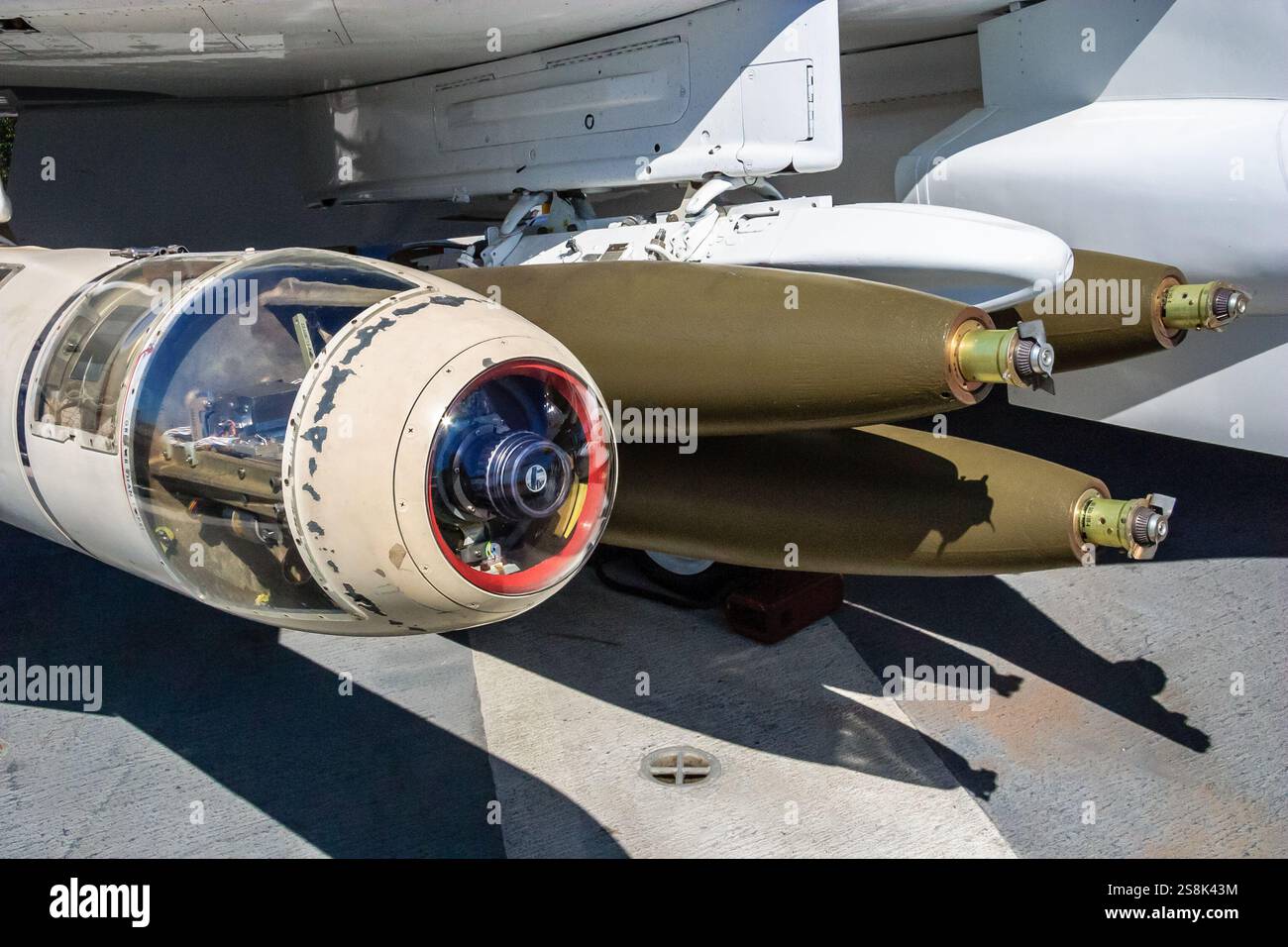 A fighter jet with a camera on the nose and three bombs on the wings ...