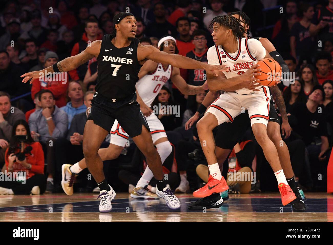 St. John's guard Simeon Wilcher, right, dribbles the ball against ...
