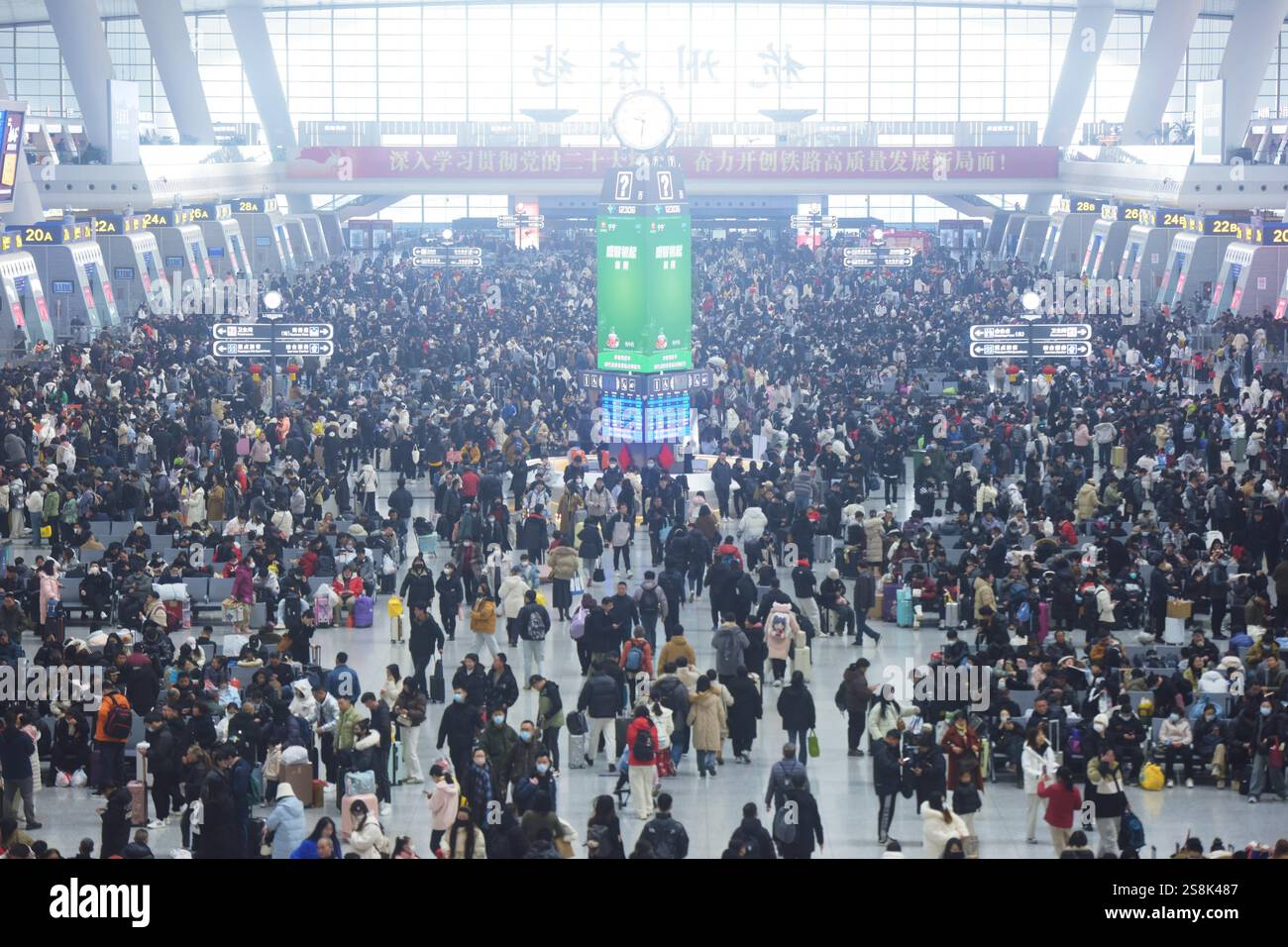 Passengers wait for trains at Hangzhoudong railway station in Hangzhou ...