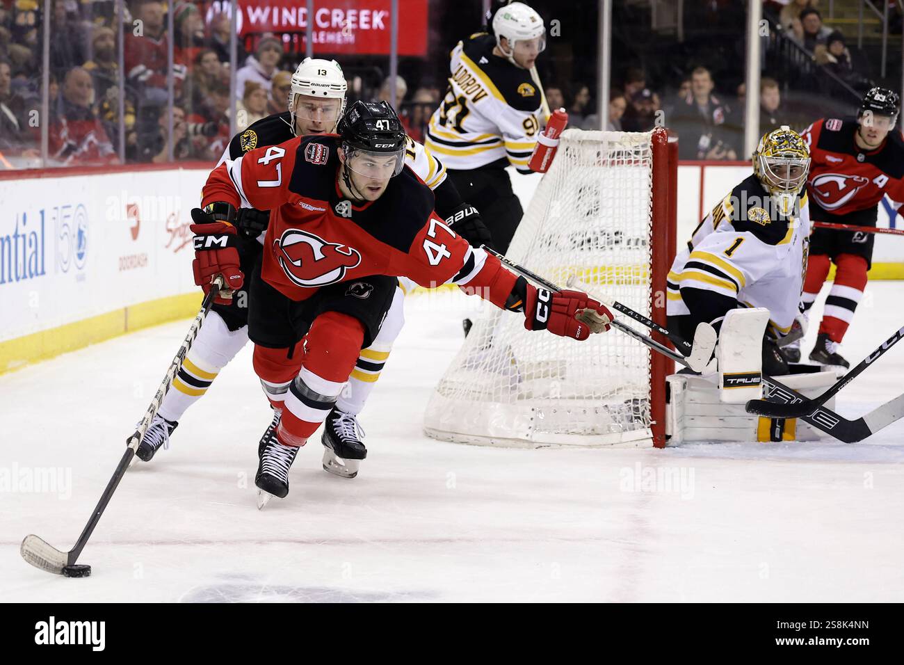 New Jersey Devils center Paul Cotter (47) controls the puck past Boston ...