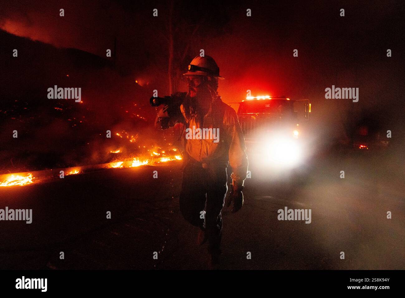A firefighter monitors flames by the Hughes Fire in Castaic, Calif ...