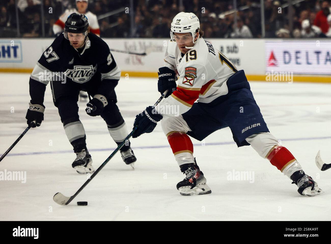 Florida Panthers winger Matthew Tkachuk, right, controls the puck away ...