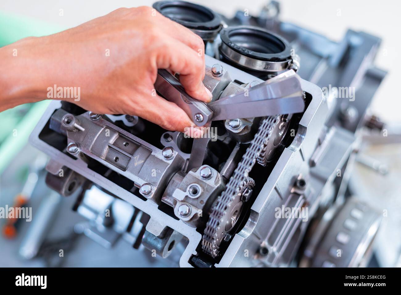 Setting valve clearance using a feeler gauge to measure clearance to ...