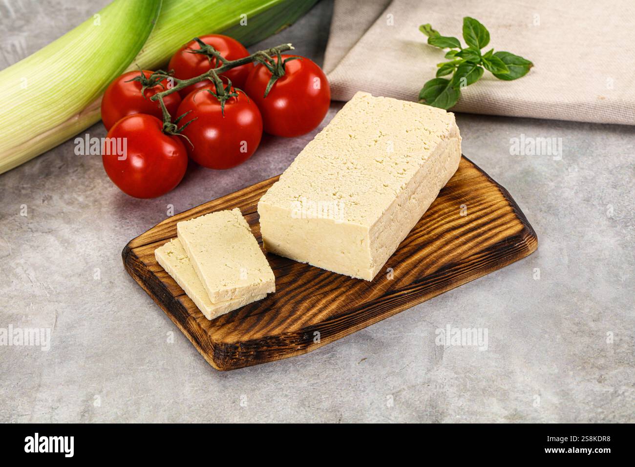 Soya vegan tofu cheese brick over board Stock Photo - Alamy