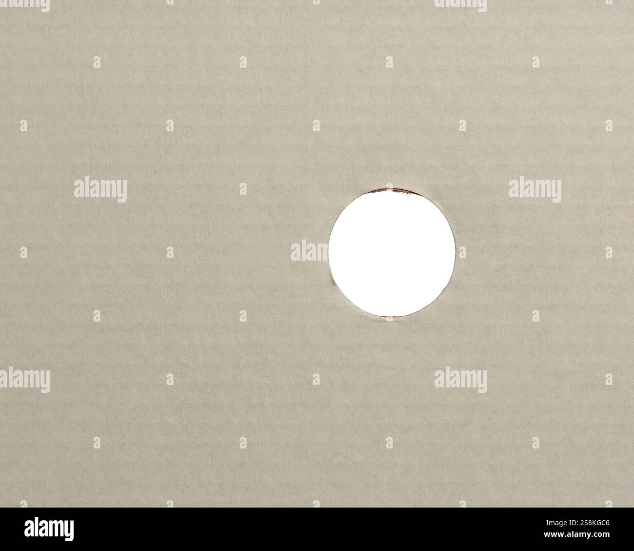 white corrugated cardboard box surface background with round hole or ...