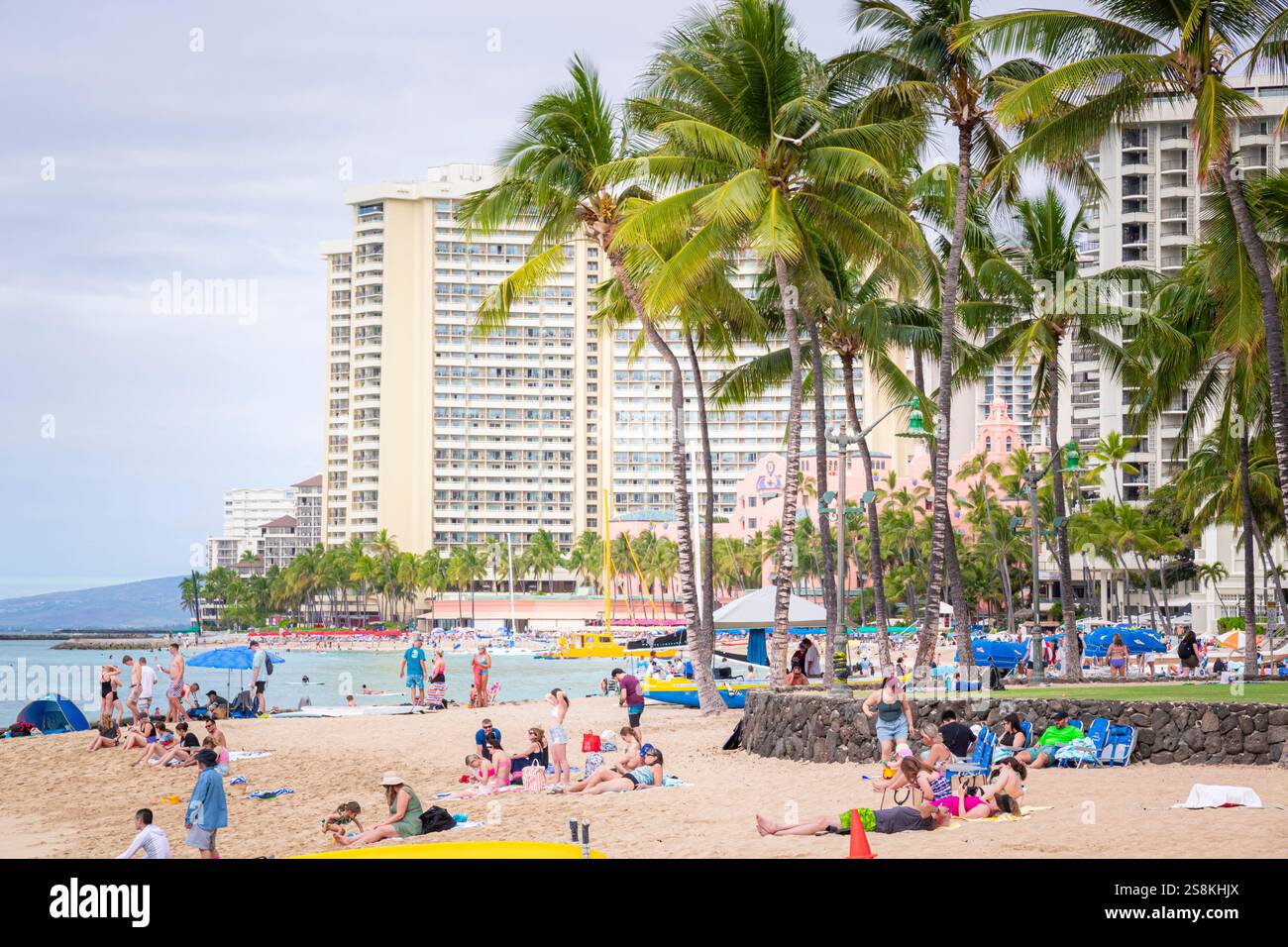 Honolulu, Hawaii, USA - February 22, 2024 - People enjoying the beach ...