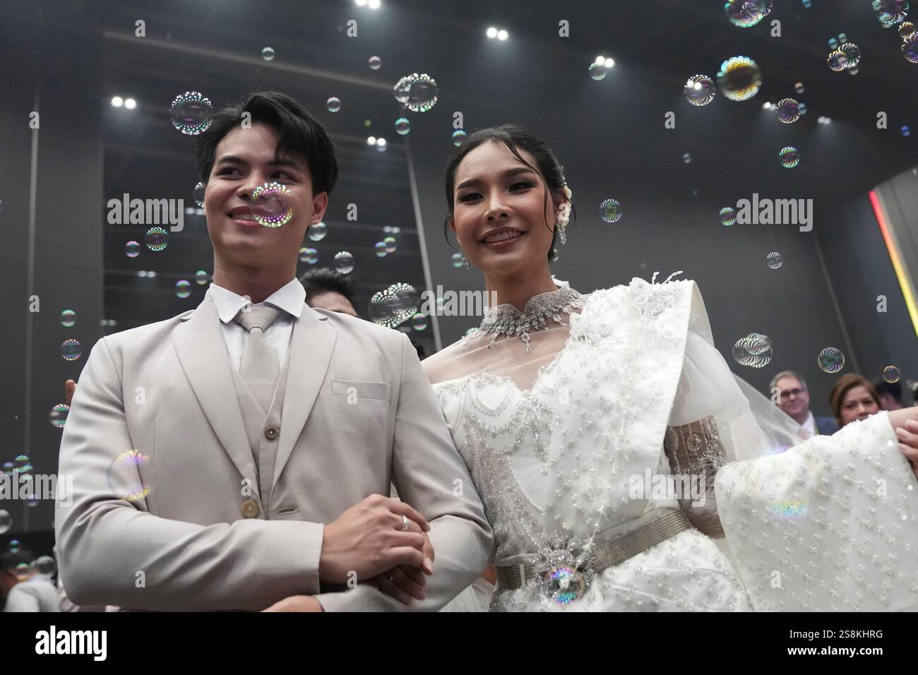 A couple from the LGBTQ+ community parade to a hall after the Marriage Equality Act took effect ...