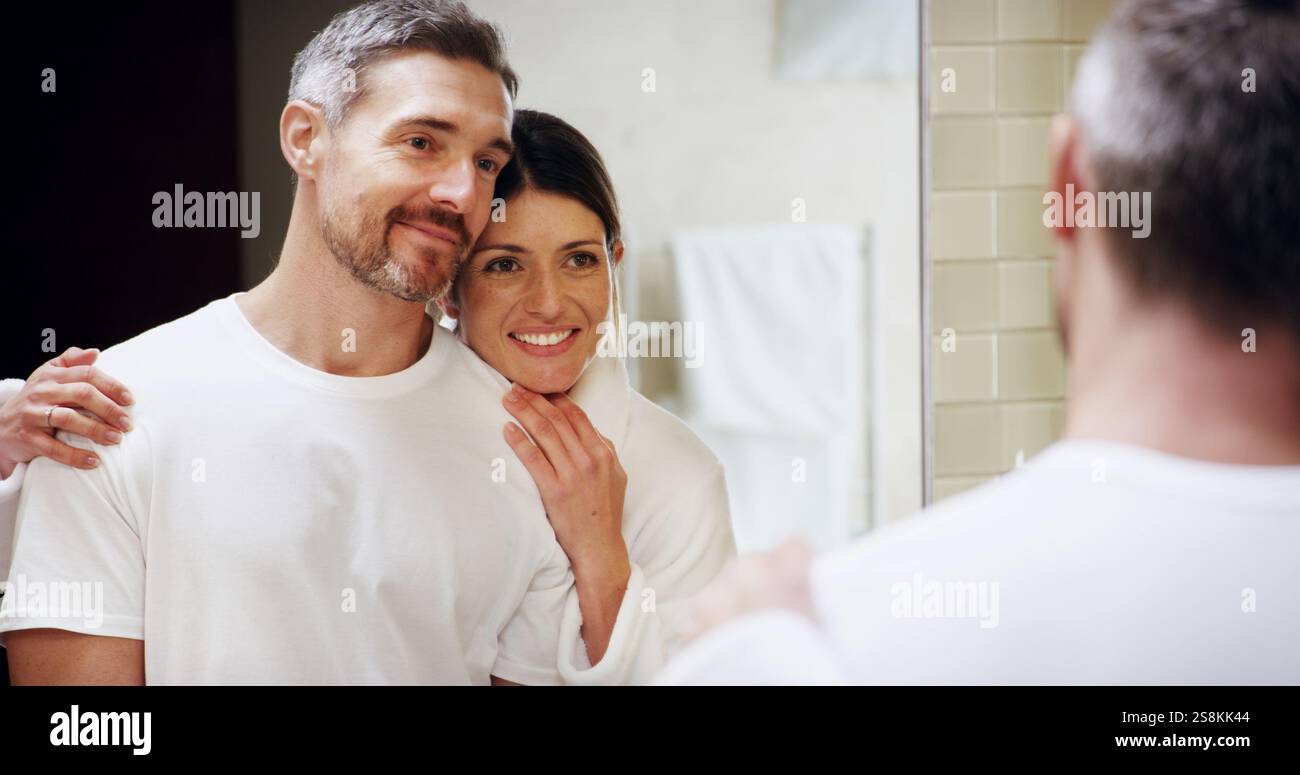 Couple, happy and hug in mirror, bathroom and care with connection ...