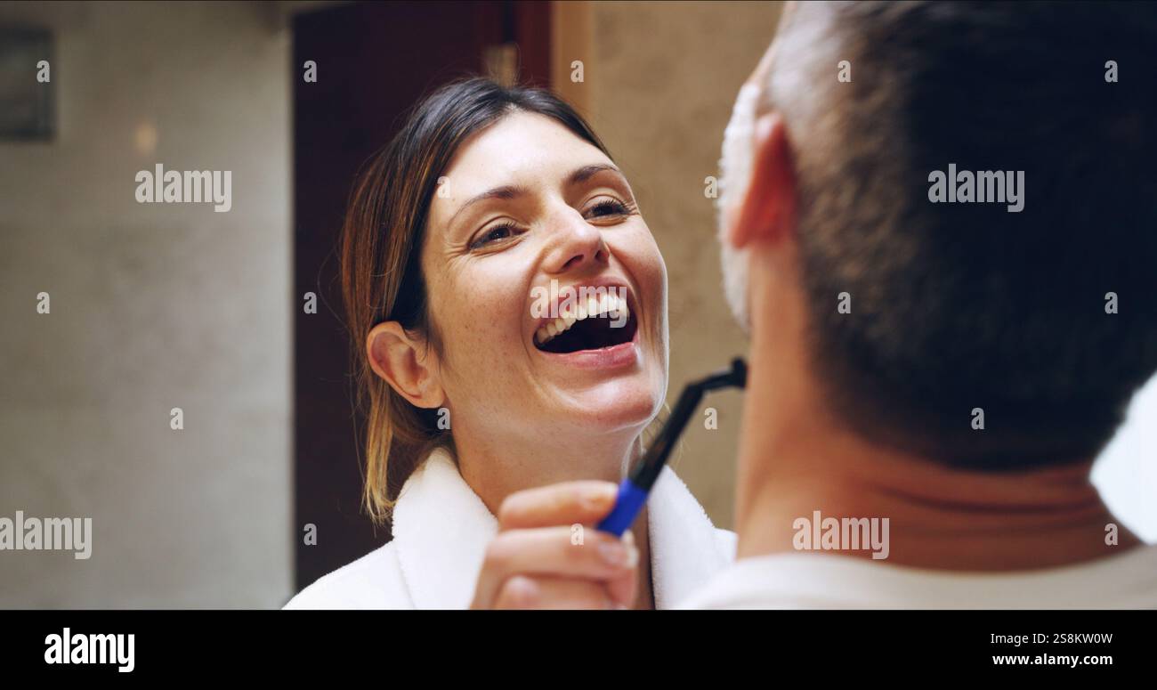 Couple, shaving and laughing with playful fun and joking together in ...
