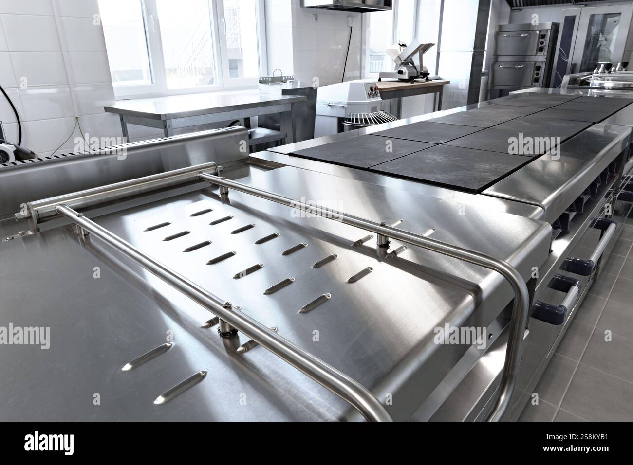 Modern stainless steel kitchen workspace with extensive prep counters ...