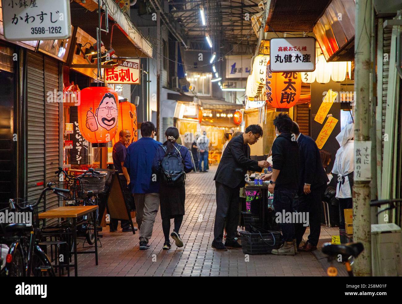 A food street restaurant at night with people outside in Tokyo, Japan ...