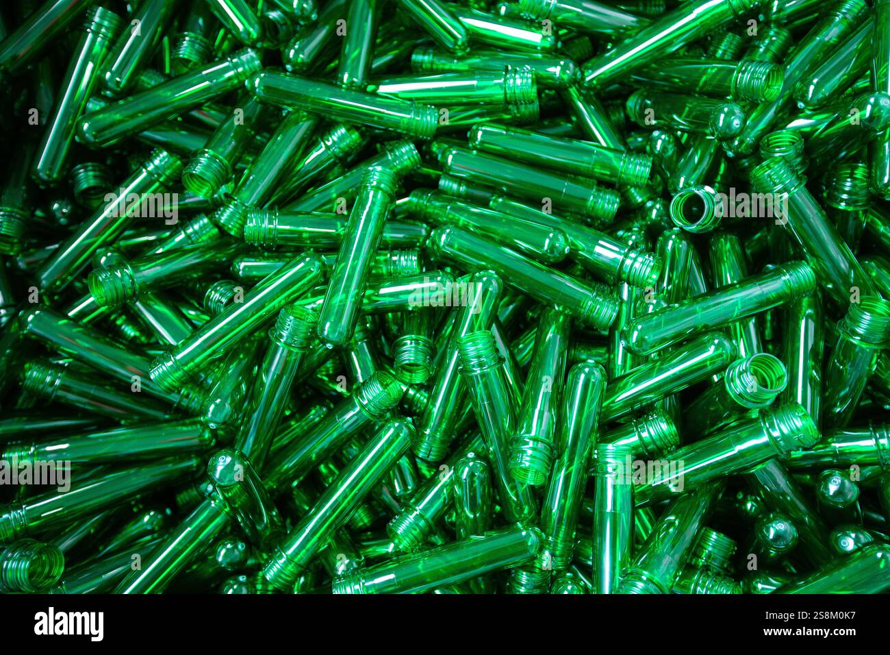 Collection of transparent green plastic tubes arranged randomly in a ...