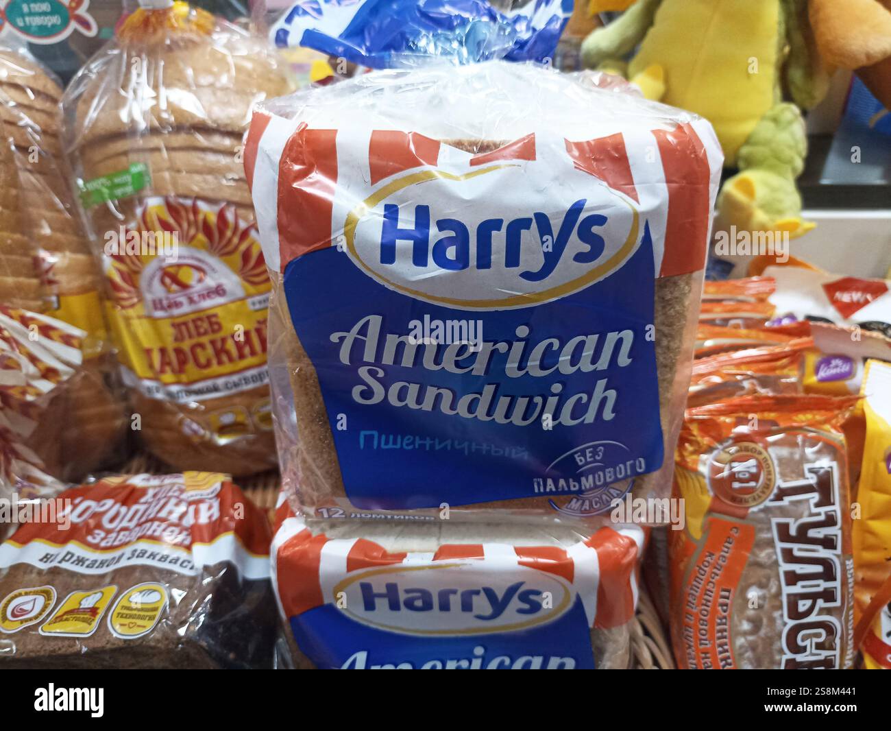 Packaged american sandwich bread in store display with various bakery ...