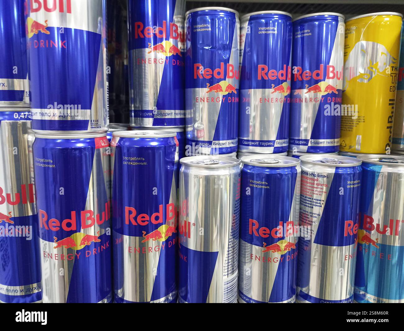 Assorted red bull energy drink cans display in store Stock Photo - Alamy