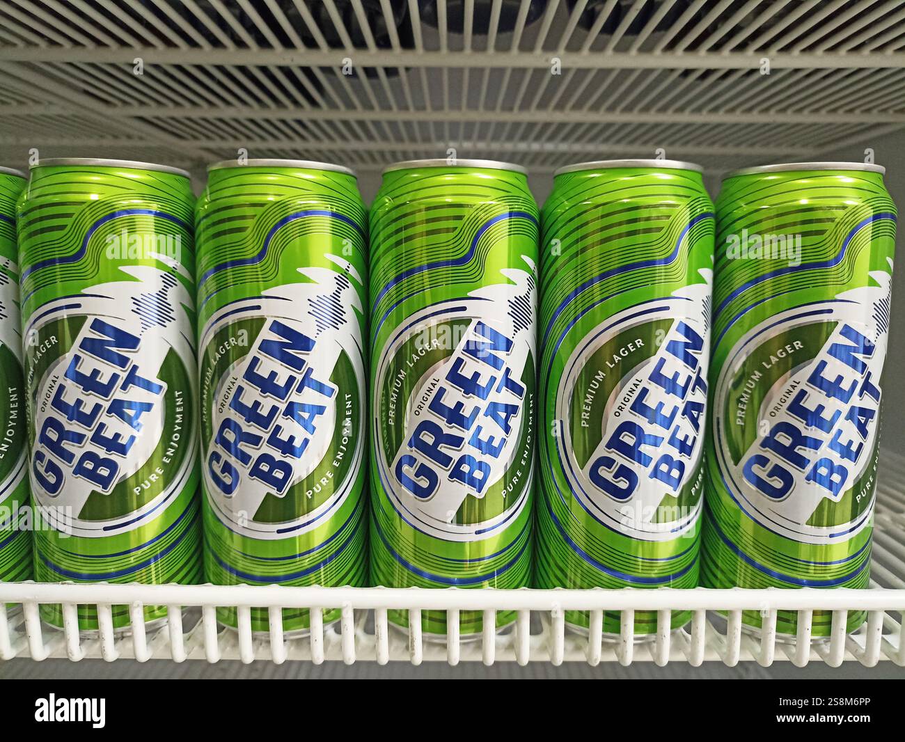 Green beat energy drink cans on refrigerator shelf displaying vibrant ...
