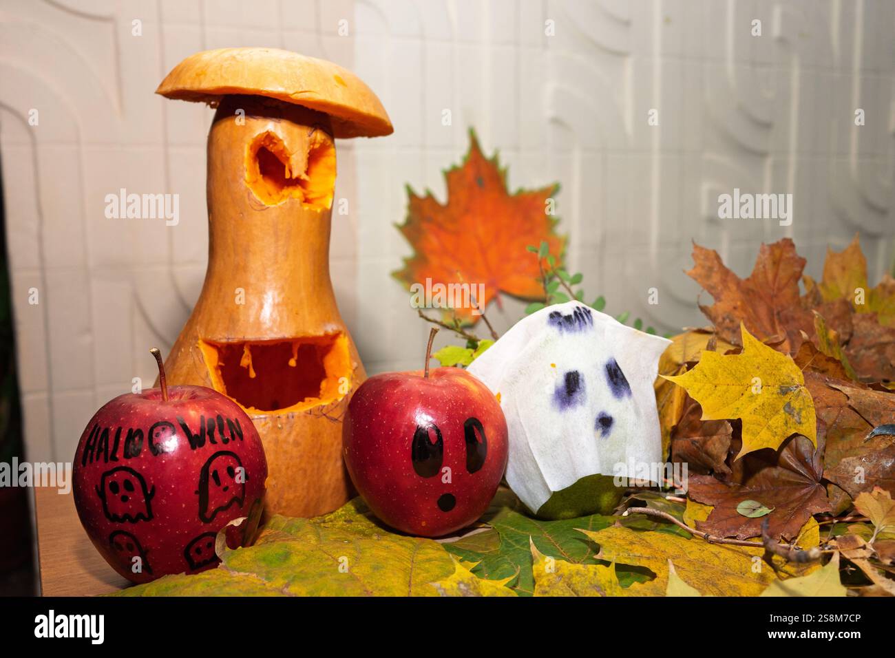 Colorful Halloween decorations display carved pumpkins and apples. A ...