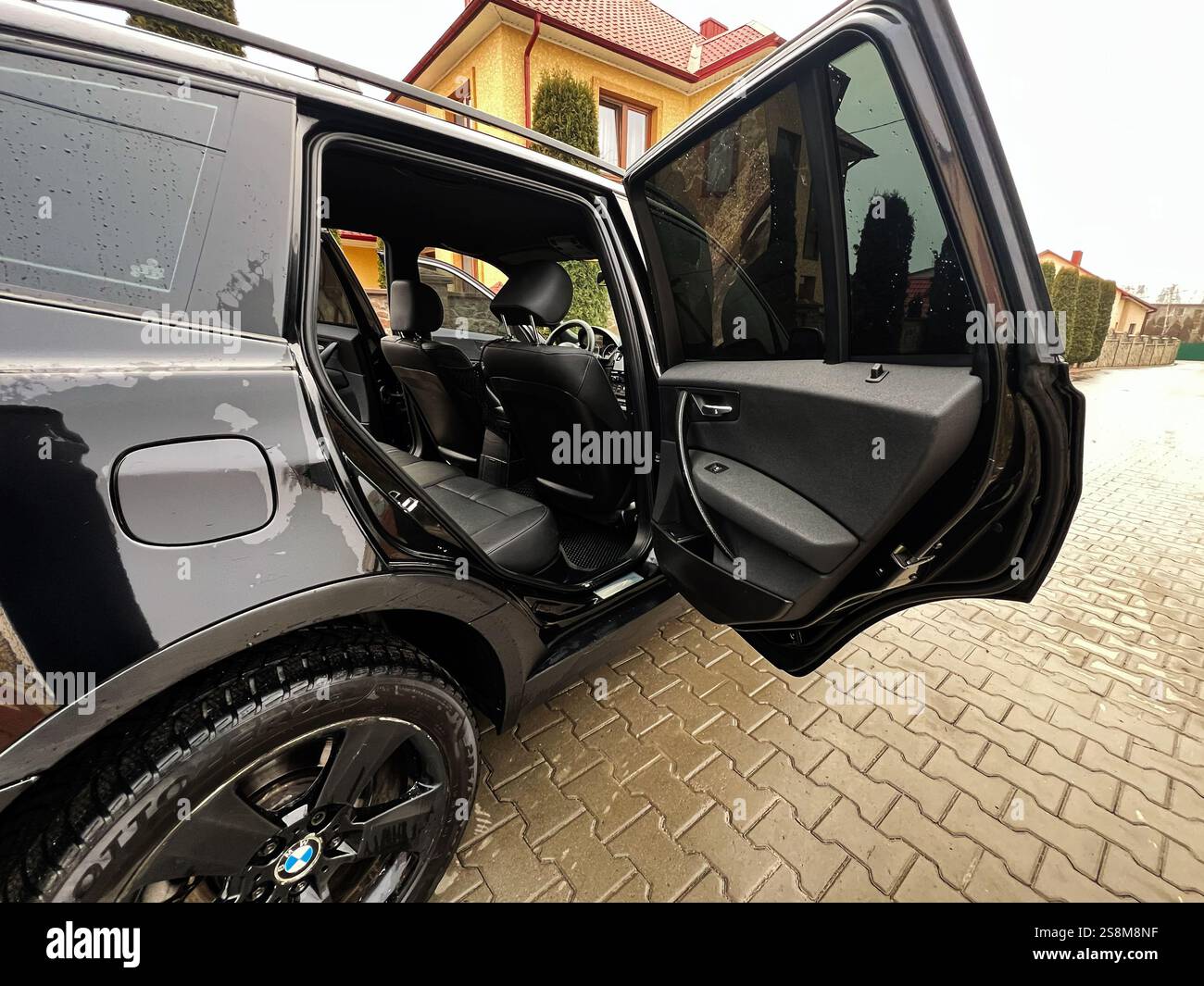 Kyiv, Ukraine - January 22, 2025: Open rear door of a modern black BMW ...
