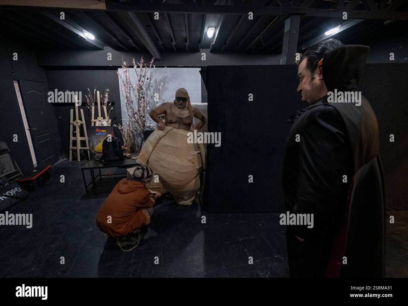 Iranian actors made up as the Mummy (C) and Dracula (R) prepare to ...