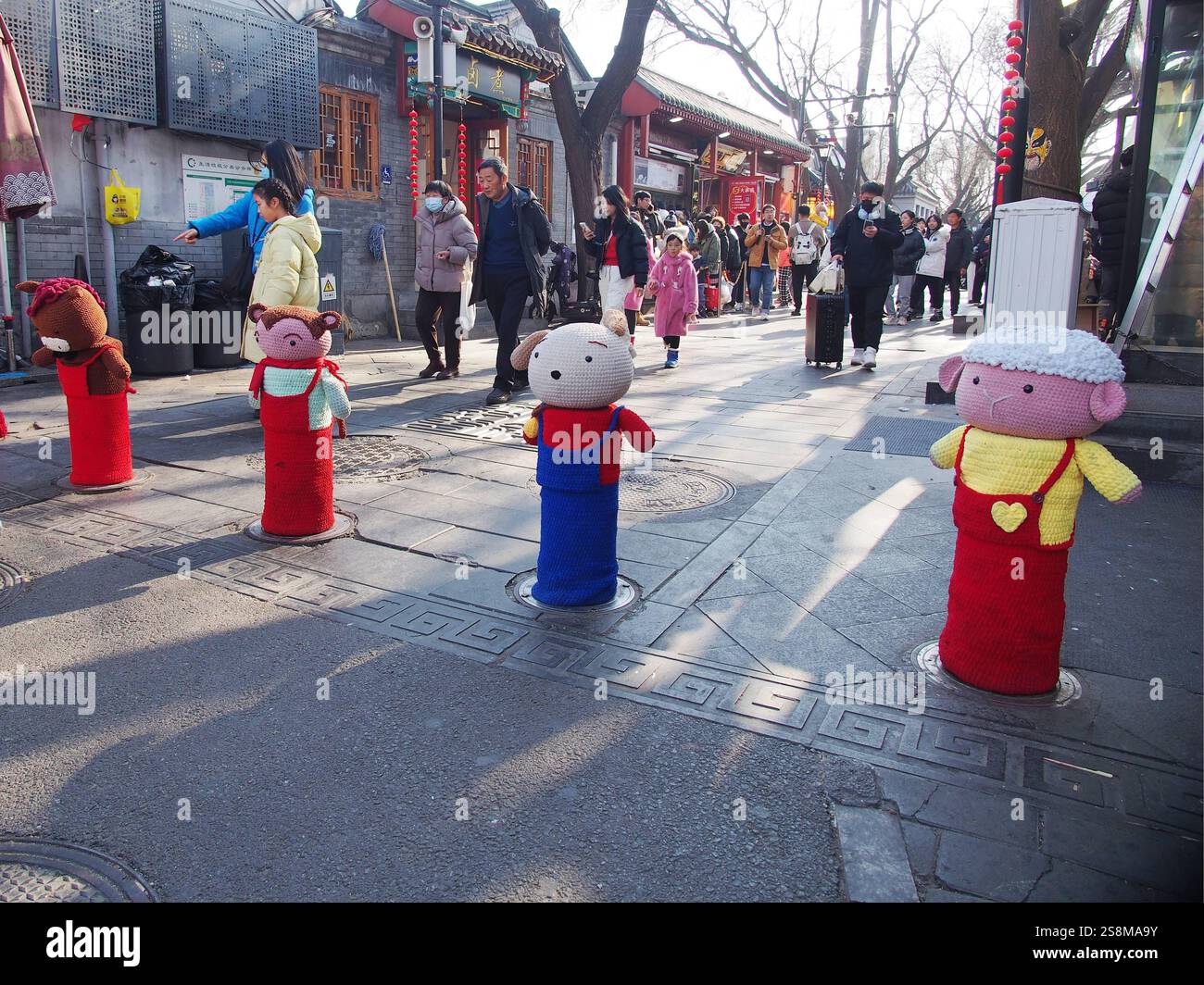 Trees in a park are put on brightly colored "sweaters" for winter in ...