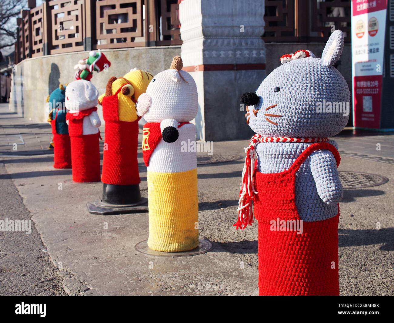 Trees in a park are put on brightly colored "sweaters" for winter in ...