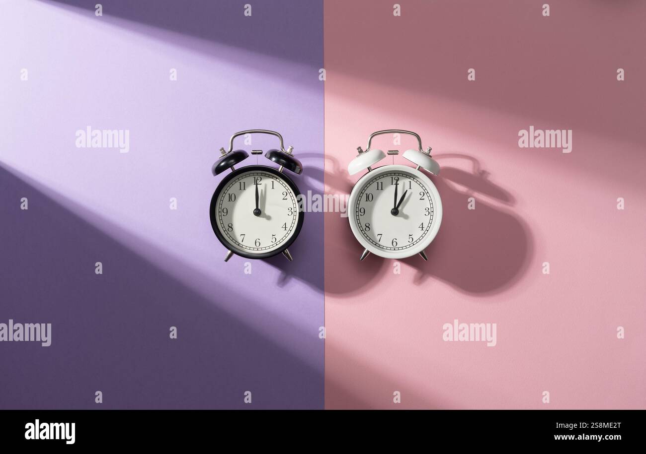 Daylight saving time: two alarm clocks are showing the time, one is set ...