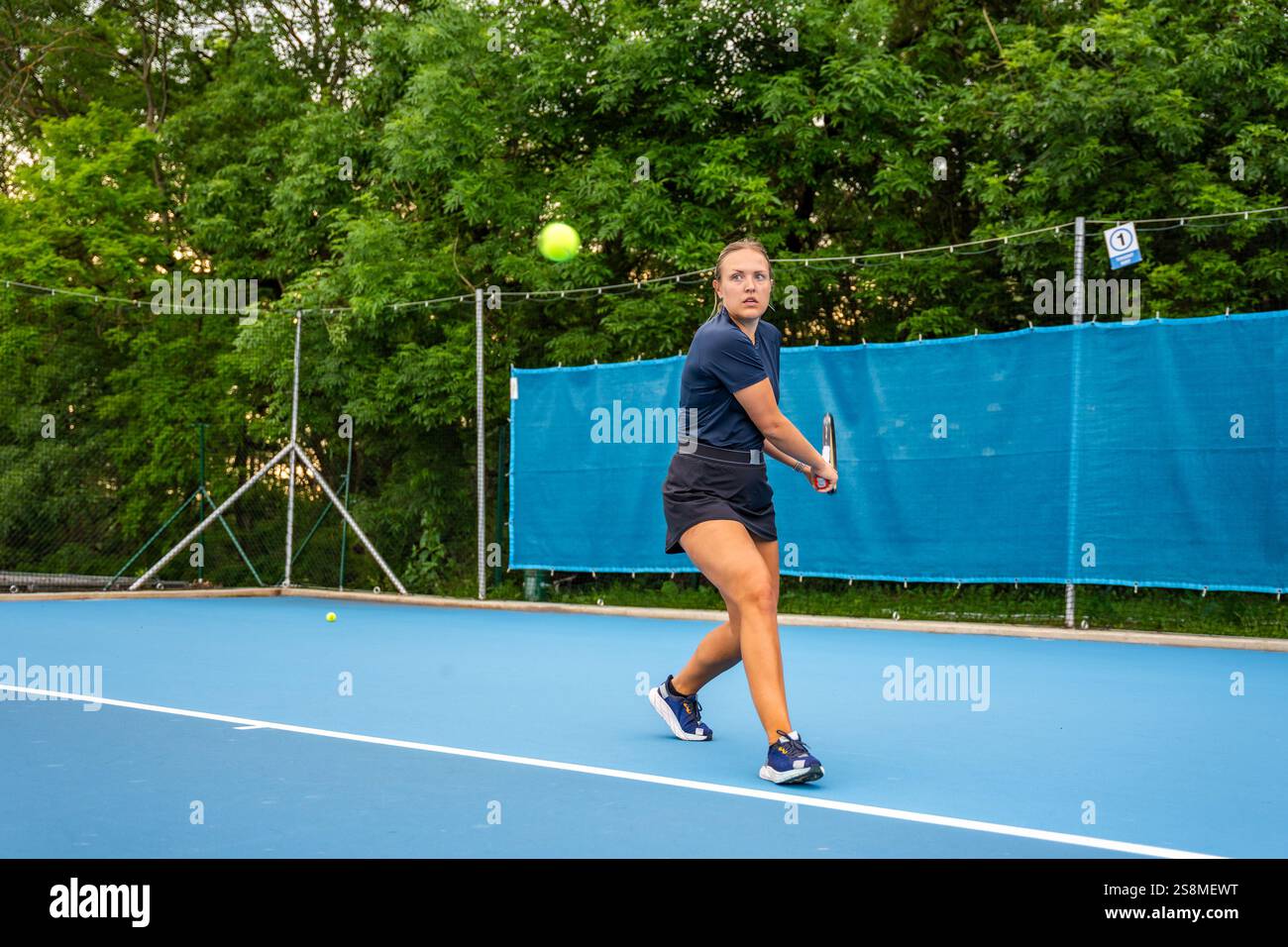 Professional female tennis player playing the tennis on outside court ...