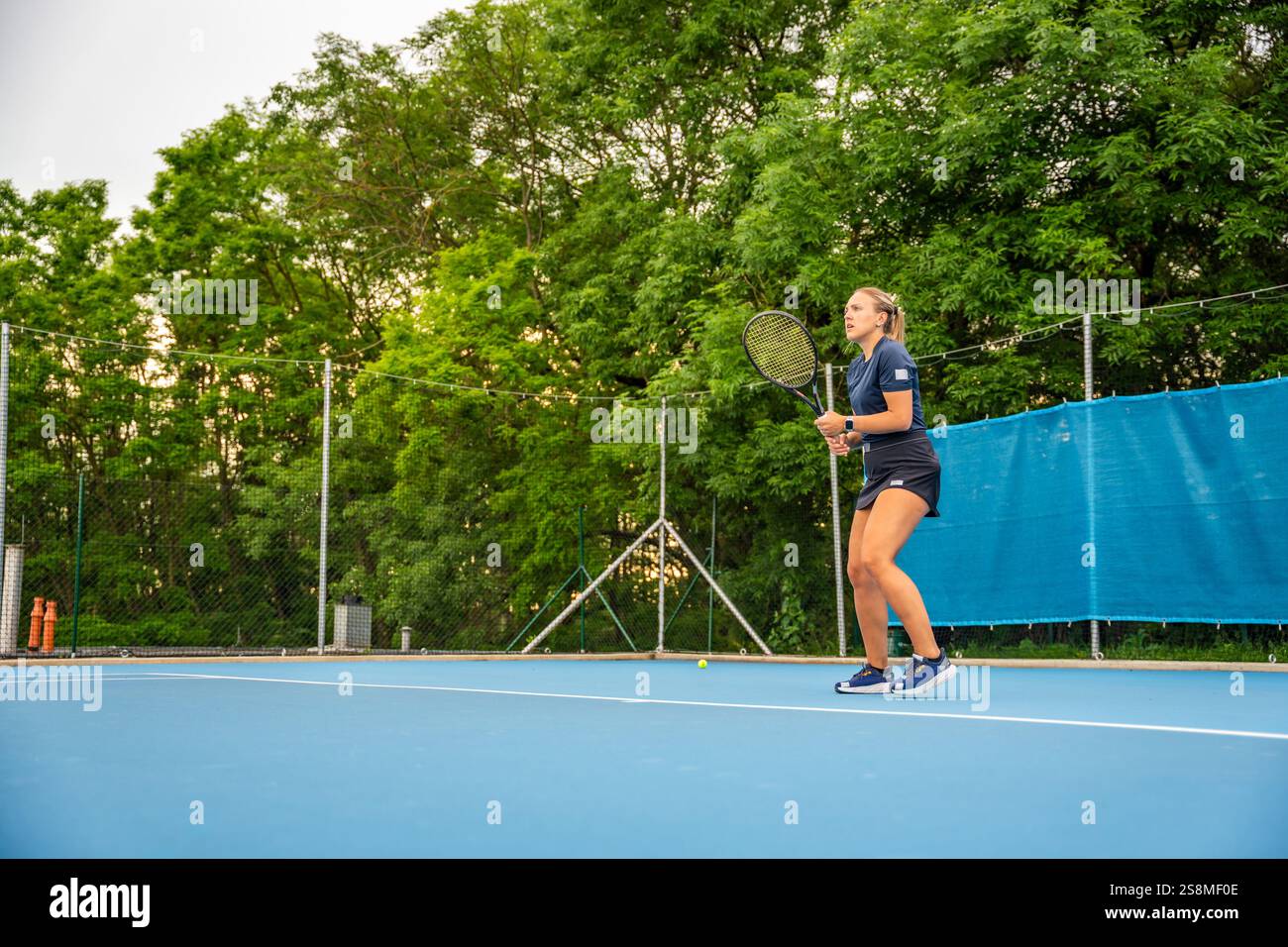 Professional female tennis player playing the tennis on outside court ...