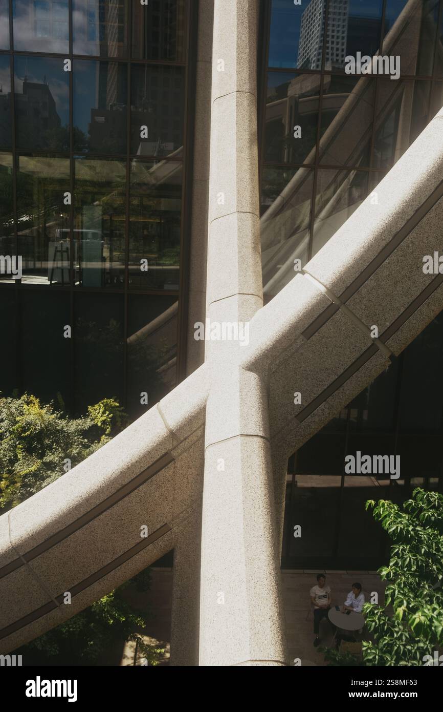 Modern architectural structure with intersecting beams and reflections ...