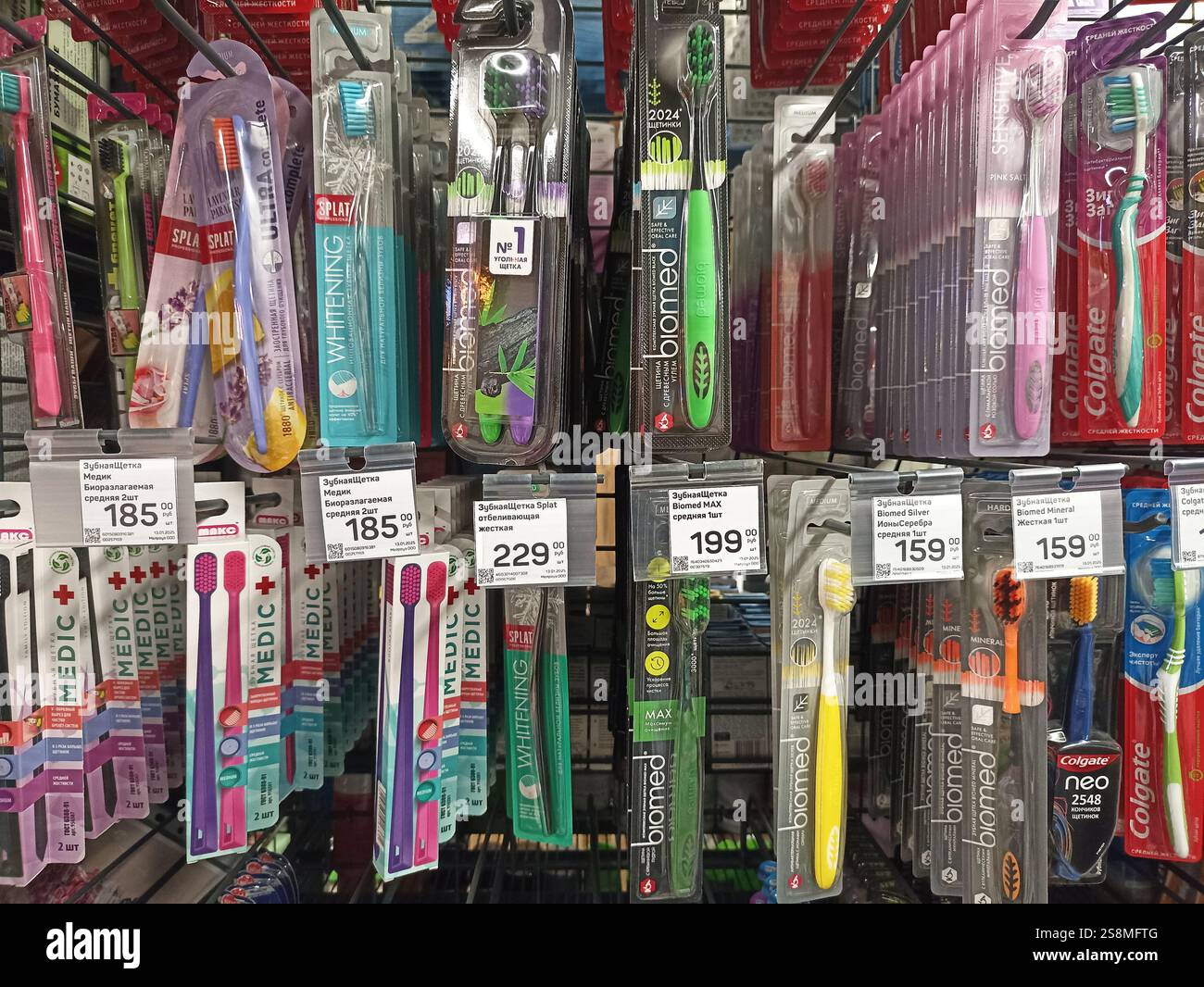 Variety of toothbrushes on store shelves with prices displayed Stock ...