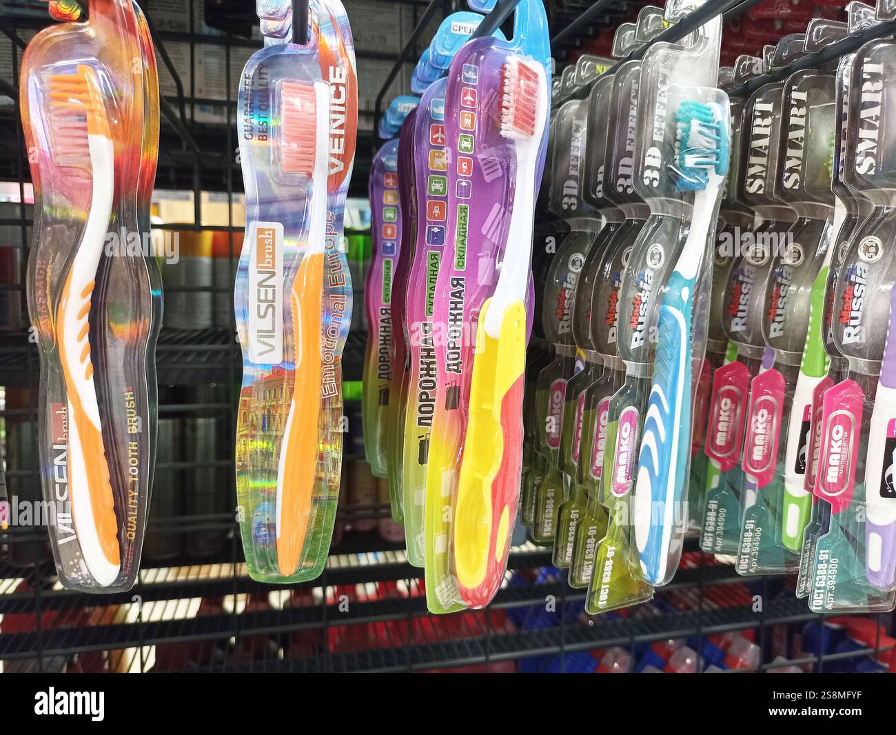 Colorful toothbrushes hanging on store shelf display Stock Photo - Alamy