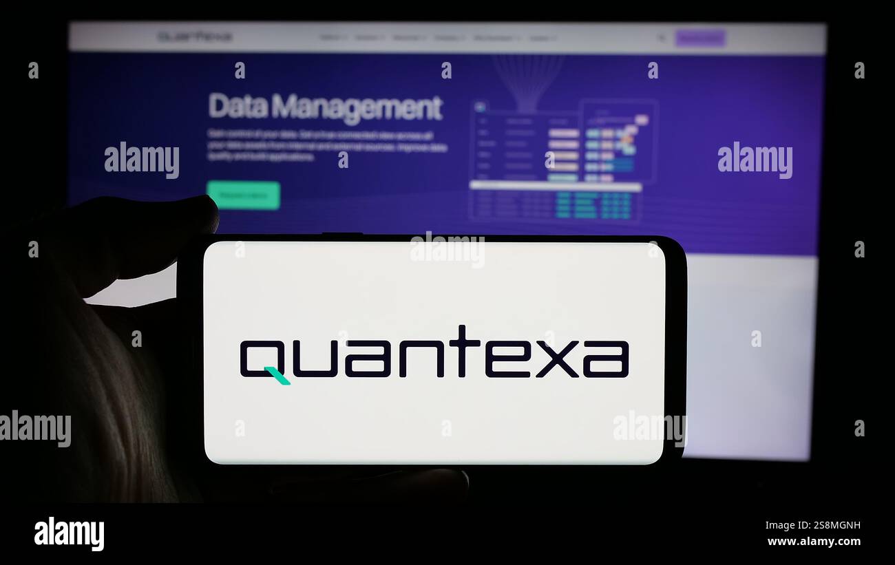 In this photo illustration, a person is holding a cellphone with the logo of British data ...