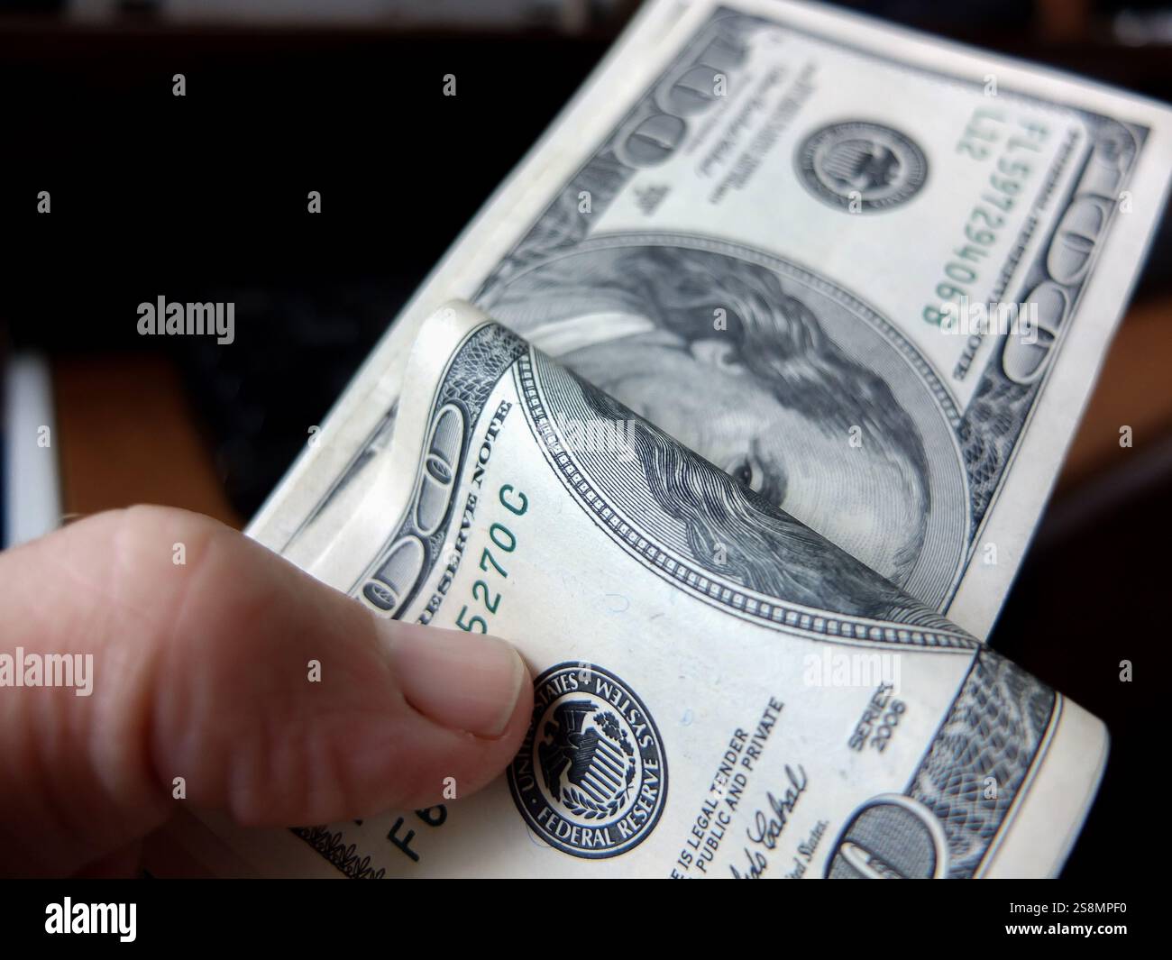 Close-up cash, 100 hundred dollar bills, 50 dollar bills, 20 dollar ...