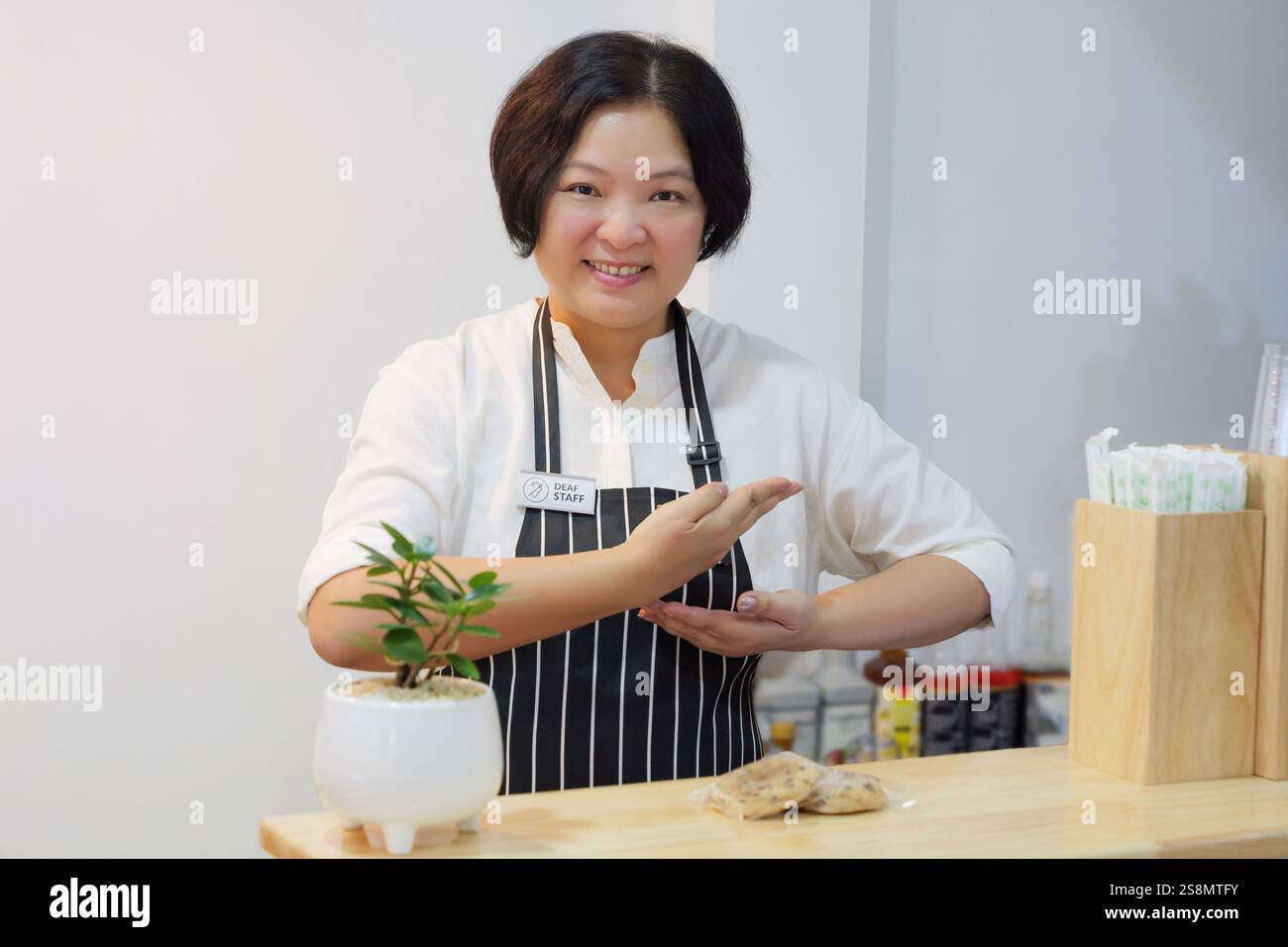 A deaf person is employed as a staff at coffee shop, pin a deaf staff ...