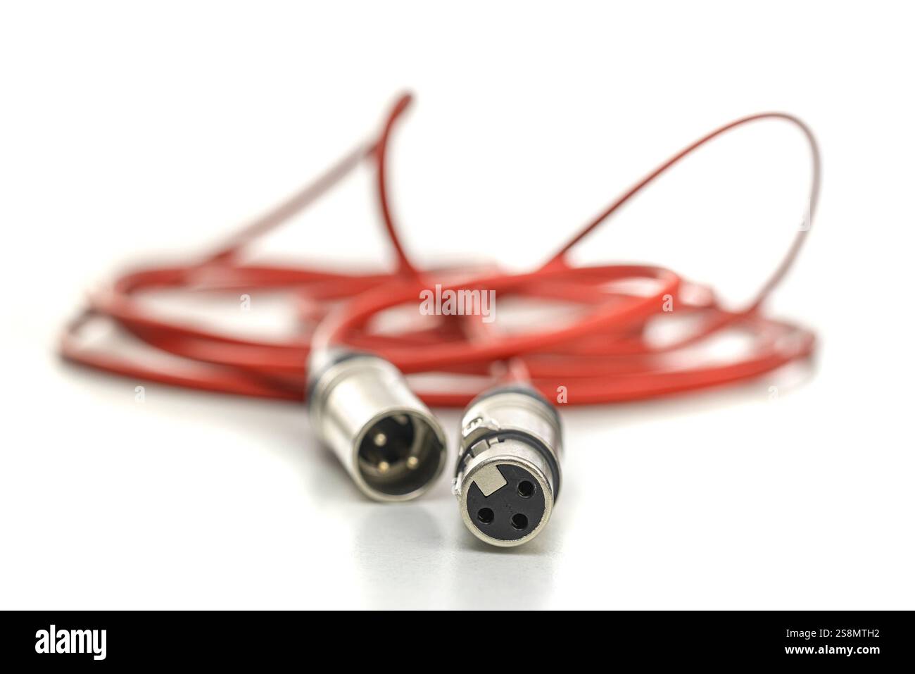 Red xlr cable connecting audio devices on white background Stock Photo ...