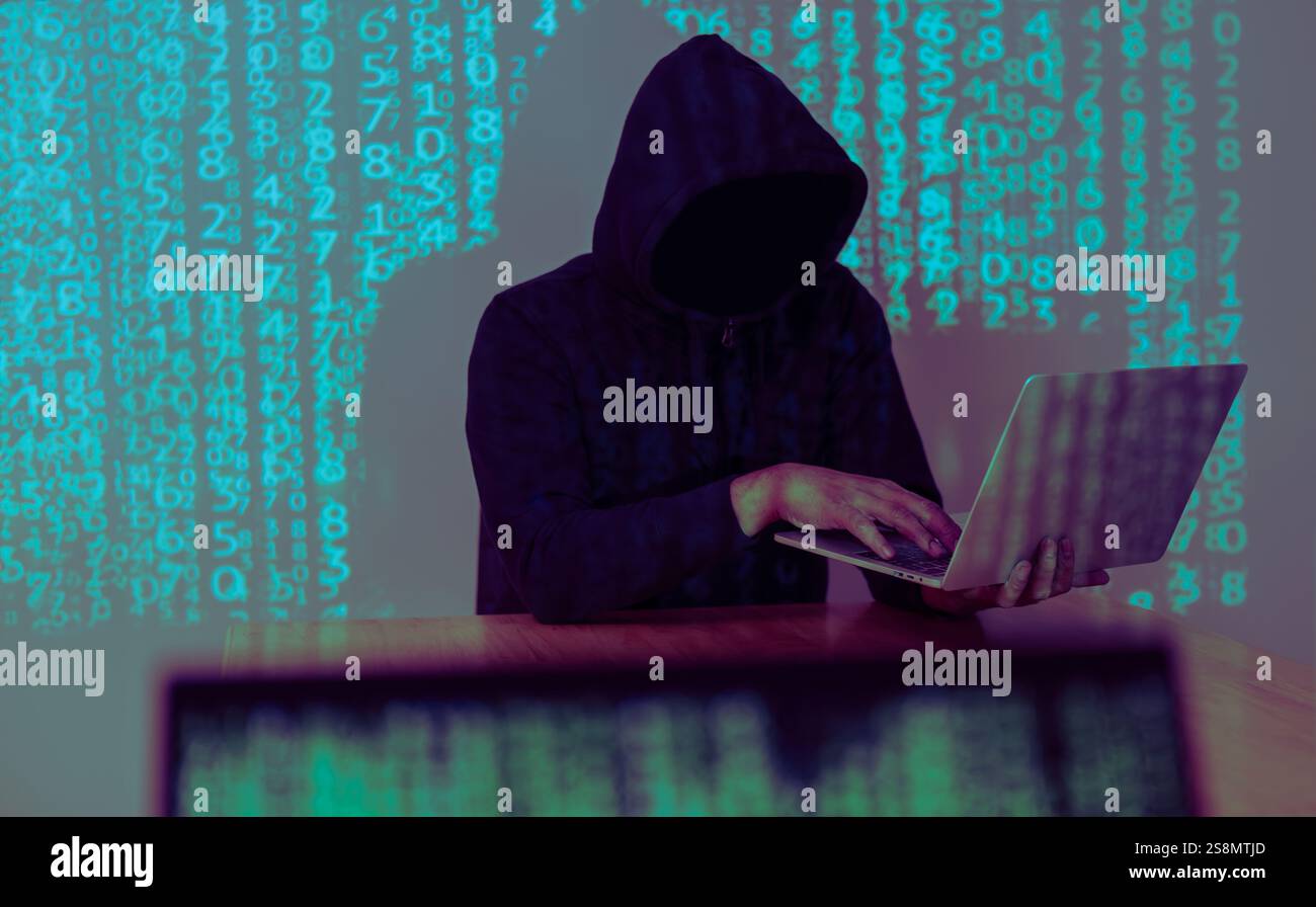 Hacker holding and using laptop over binary code digital background. Hacking the Internet ...