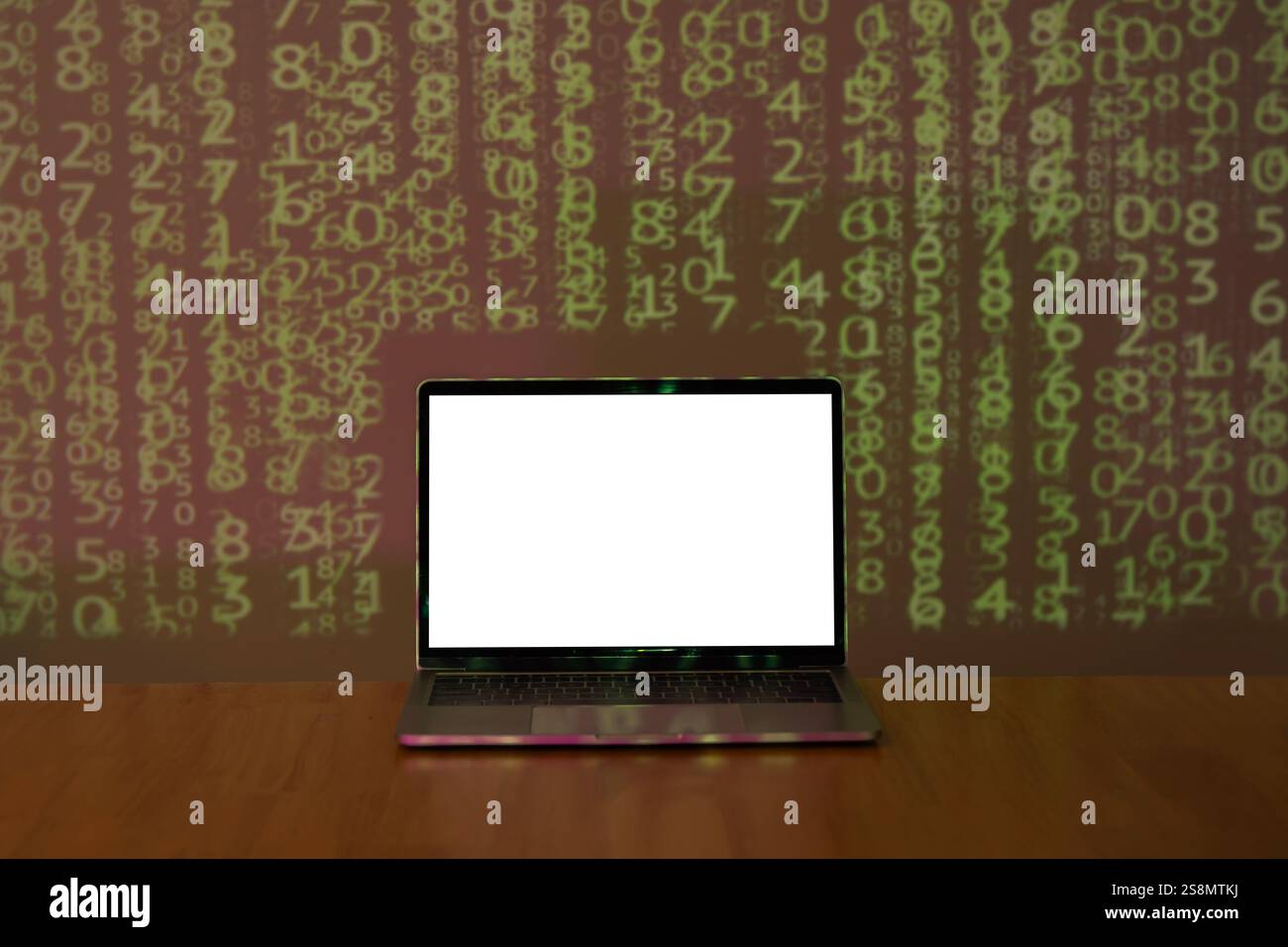 Laptop with space for your message on wooden table over binary code background in dark room ...