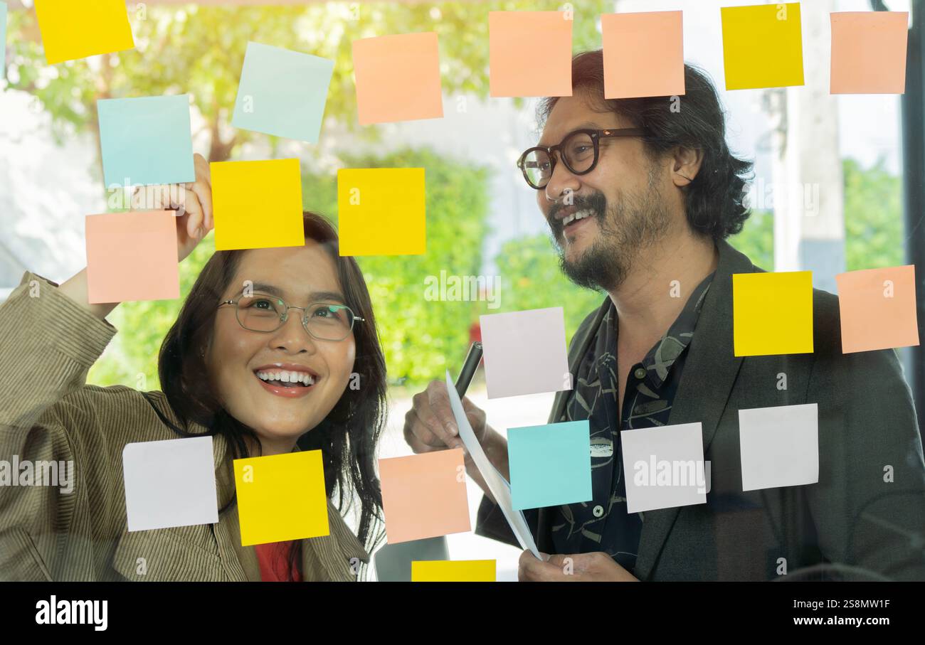 Business people meeting at office and use post it notes to share idea ...
