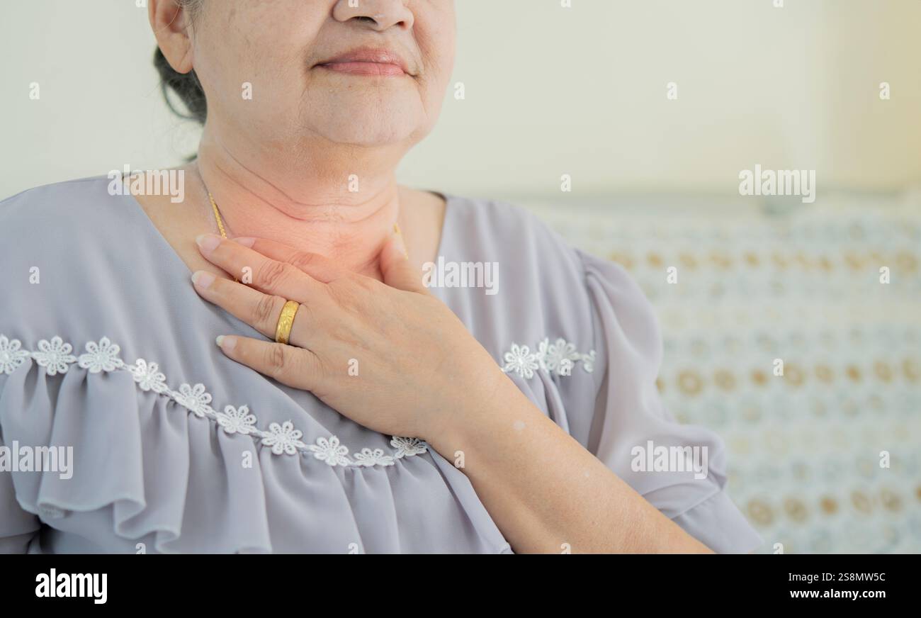 Sick senior Asian women touching neck unwell coughing with sore throat ...