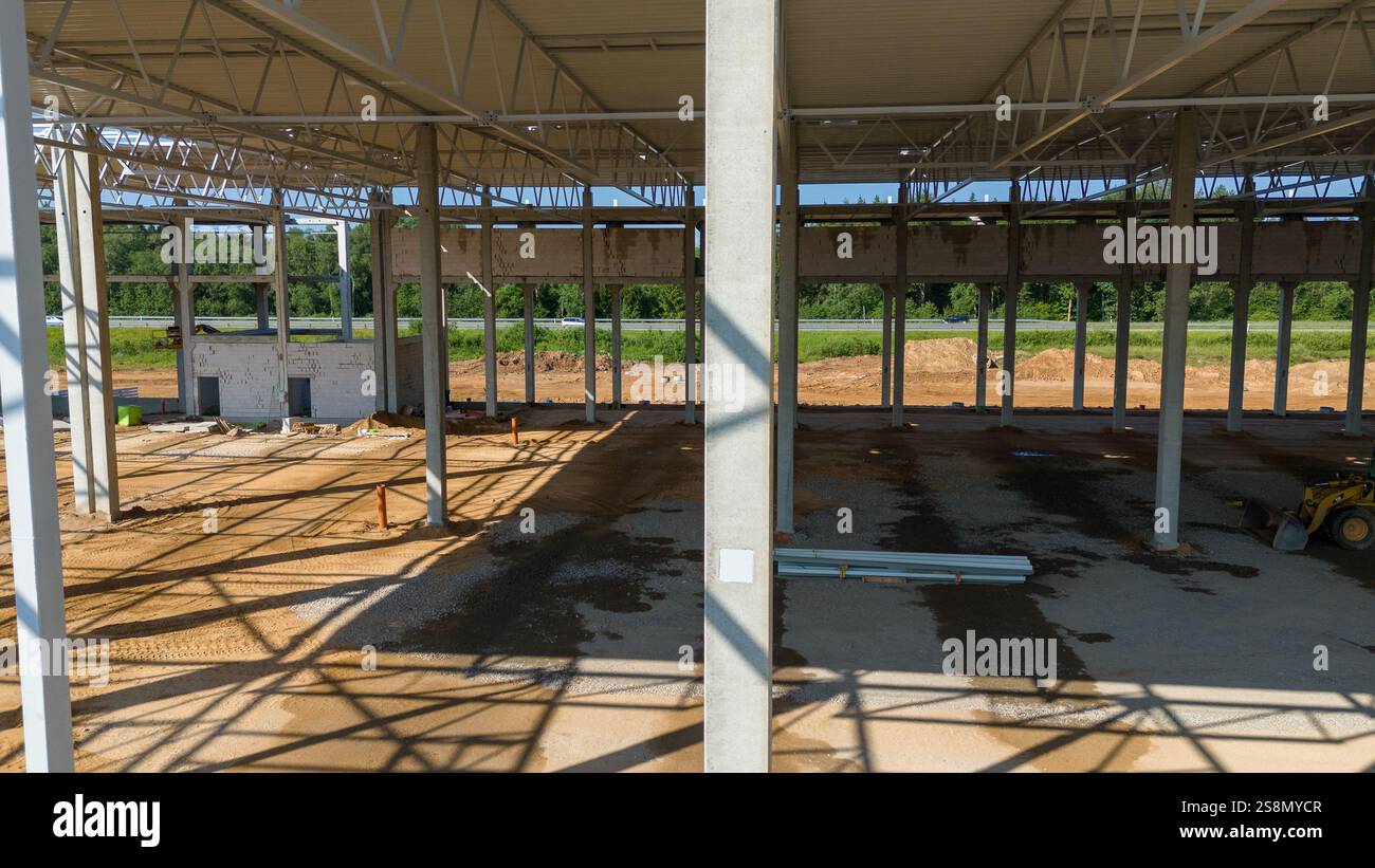 A construction site with a partially built industrial building, showing ...
